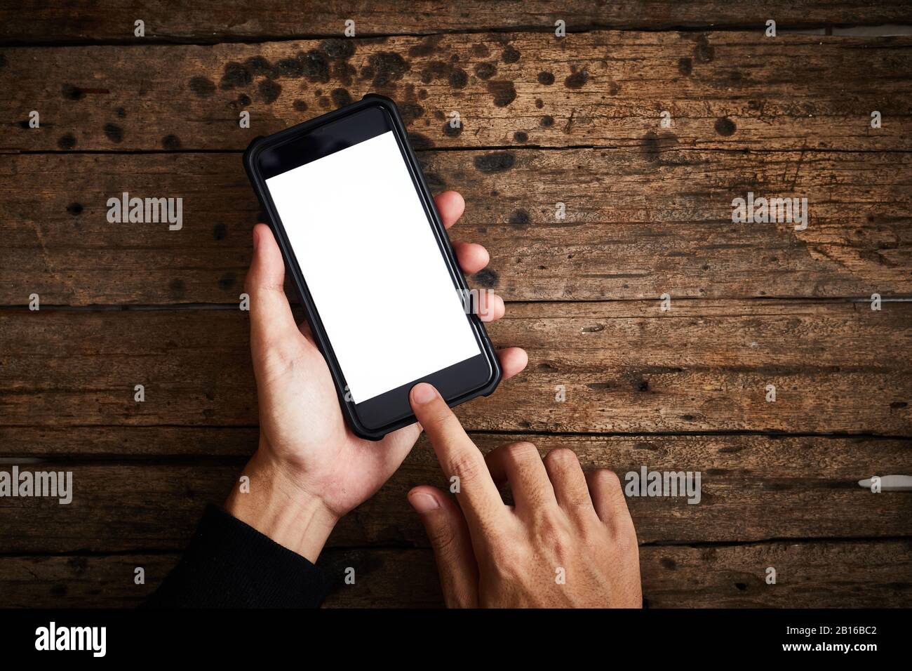 Smartphone white screen on wooden table.Top view Stock Photo - Alamy