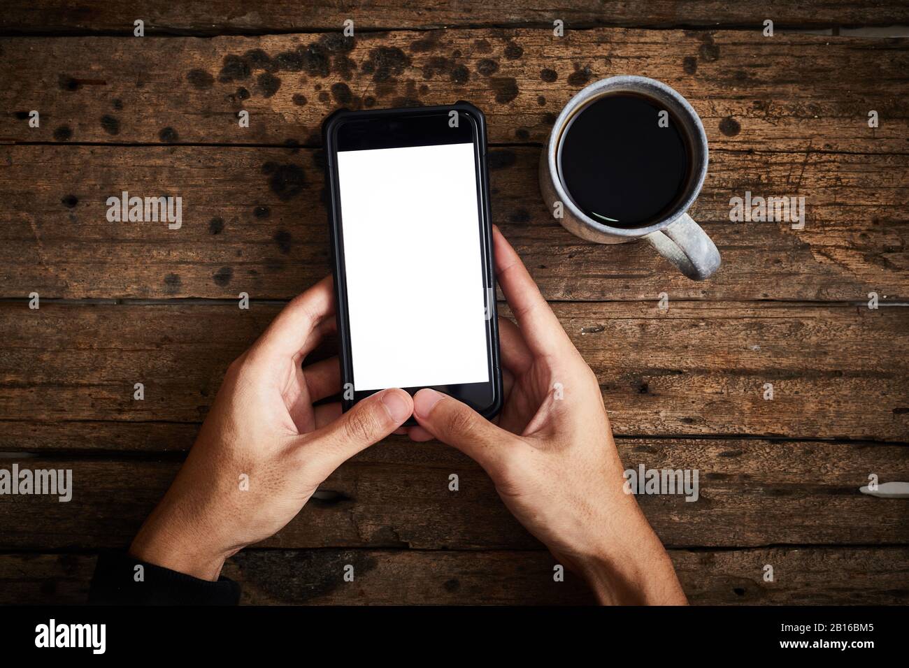 Smartphone white screen on wooden table.Top view Stock Photo - Alamy