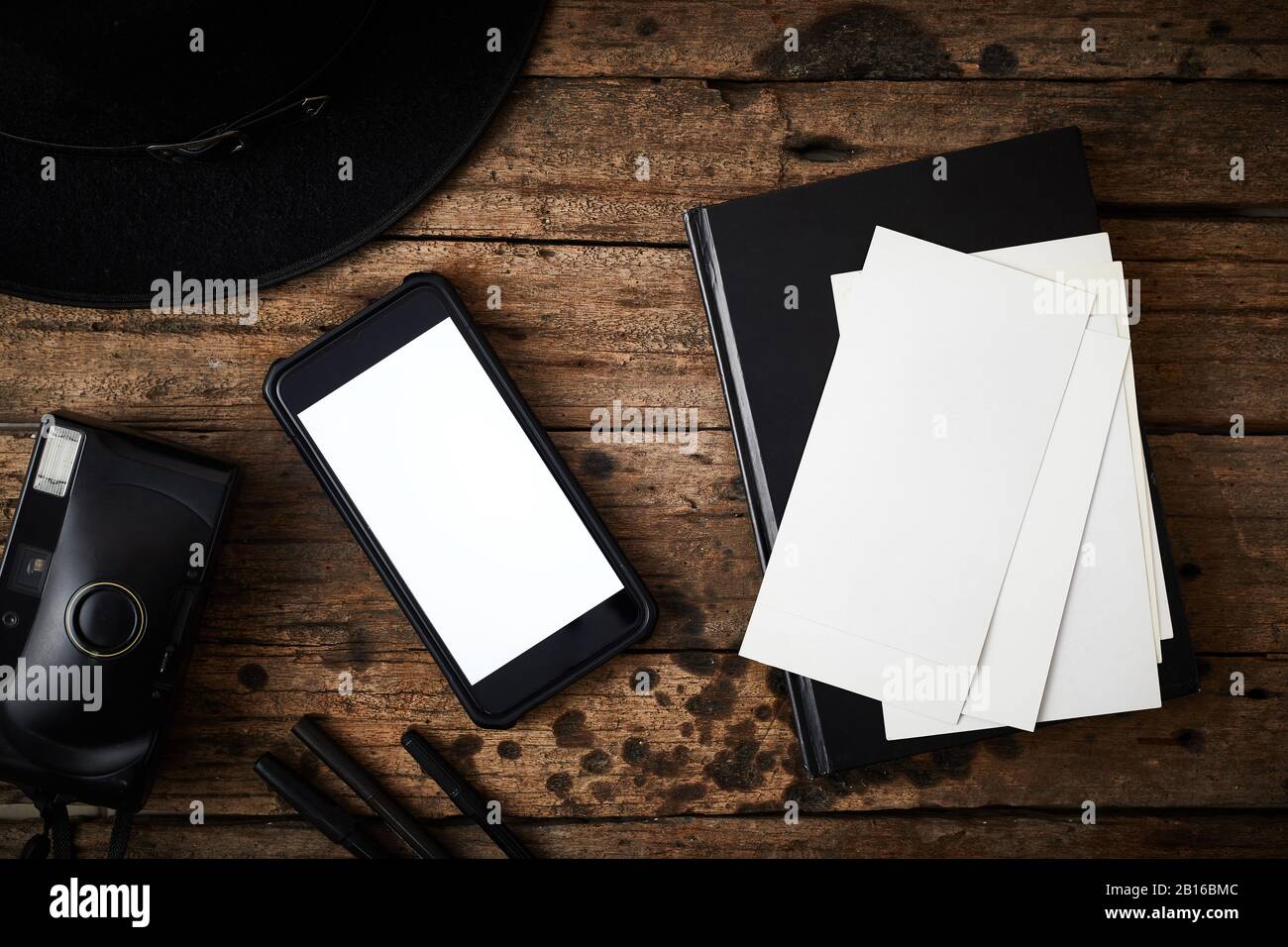 Smartphone white screen on wooden table.Top view Stock Photo - Alamy