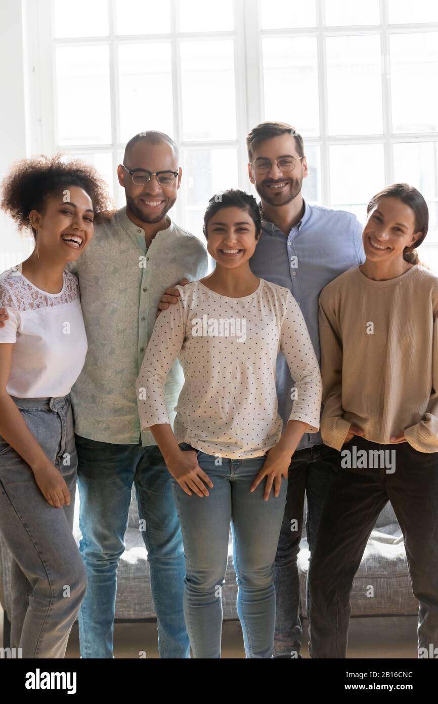 Vertical view five multi-ethnic best friends posing indoors Stock Photo ...