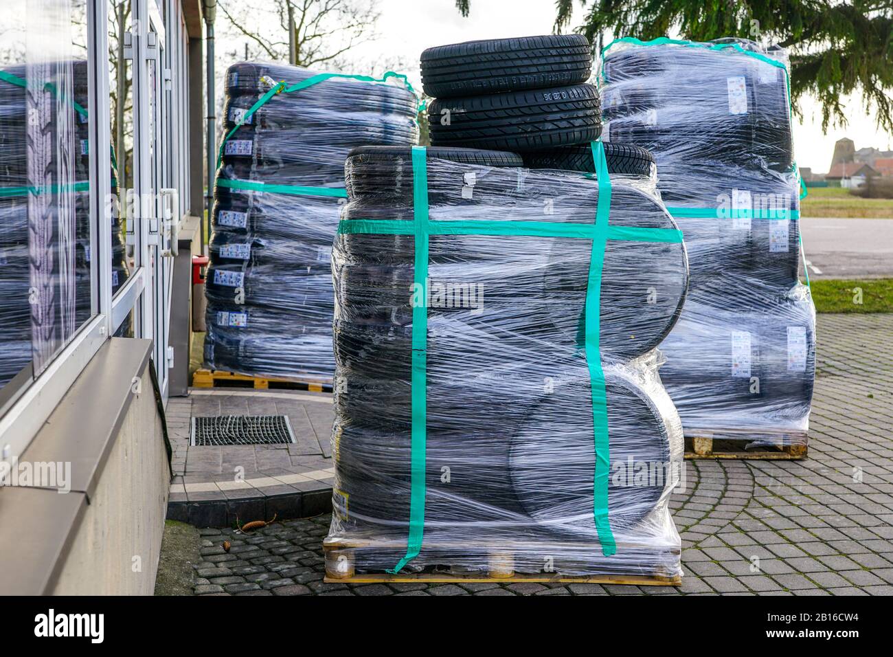 delivery of new season tires to the store on pallets Stock Photo - Alamy