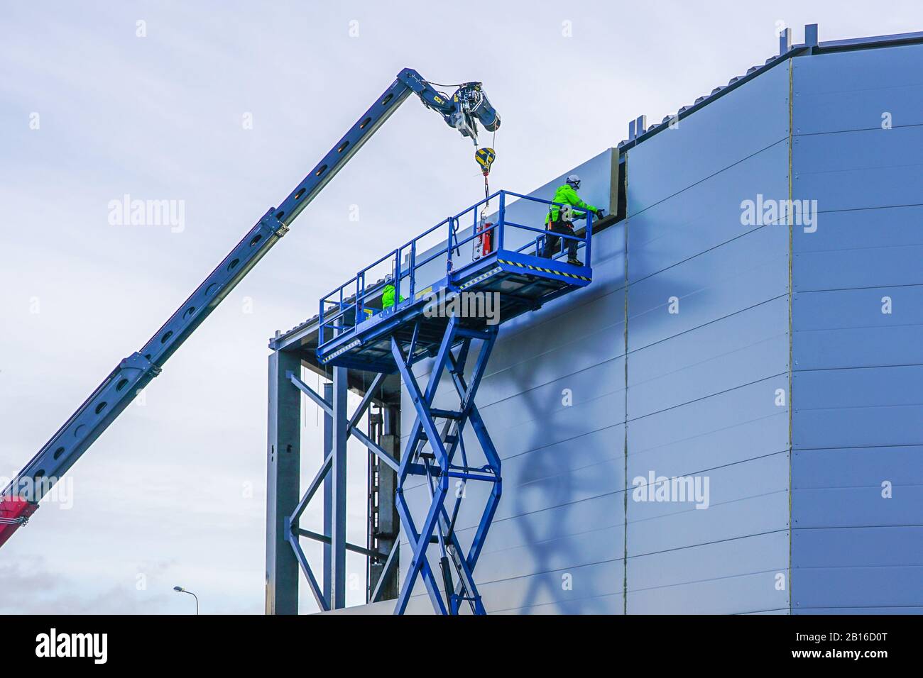 sandwich panels wall mounting using crane and scissor lift Stock Photo ...