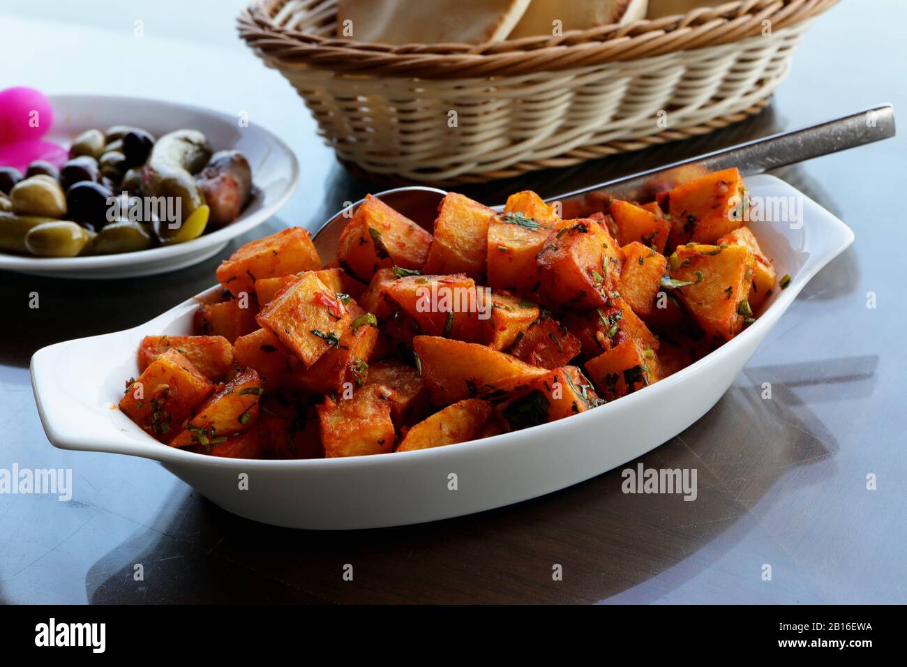 Spicy appetizer of cubed potato called Batata Harra Stock Photo - Alamy