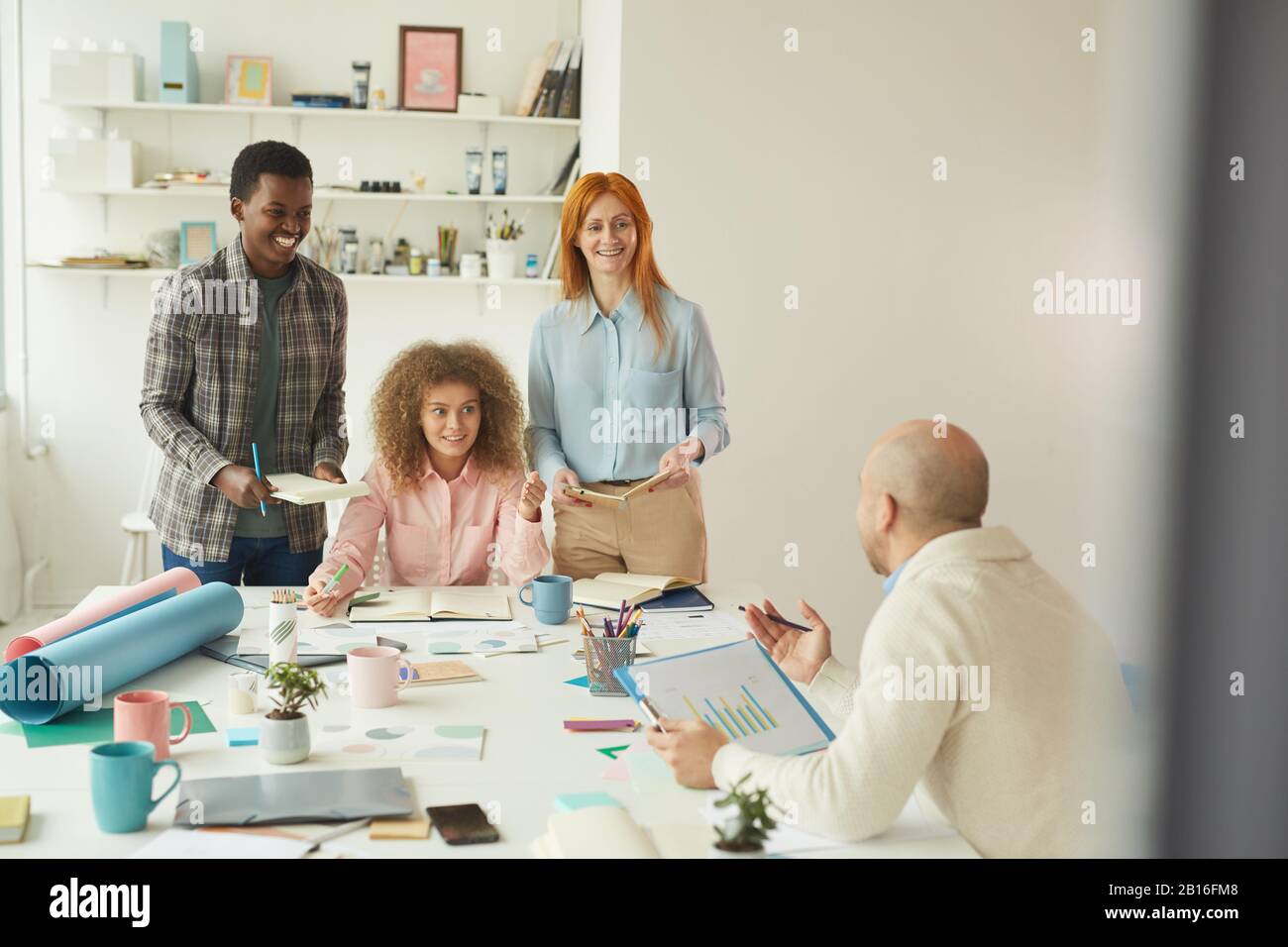 Portrait of diverse business team collaborating on business project ...