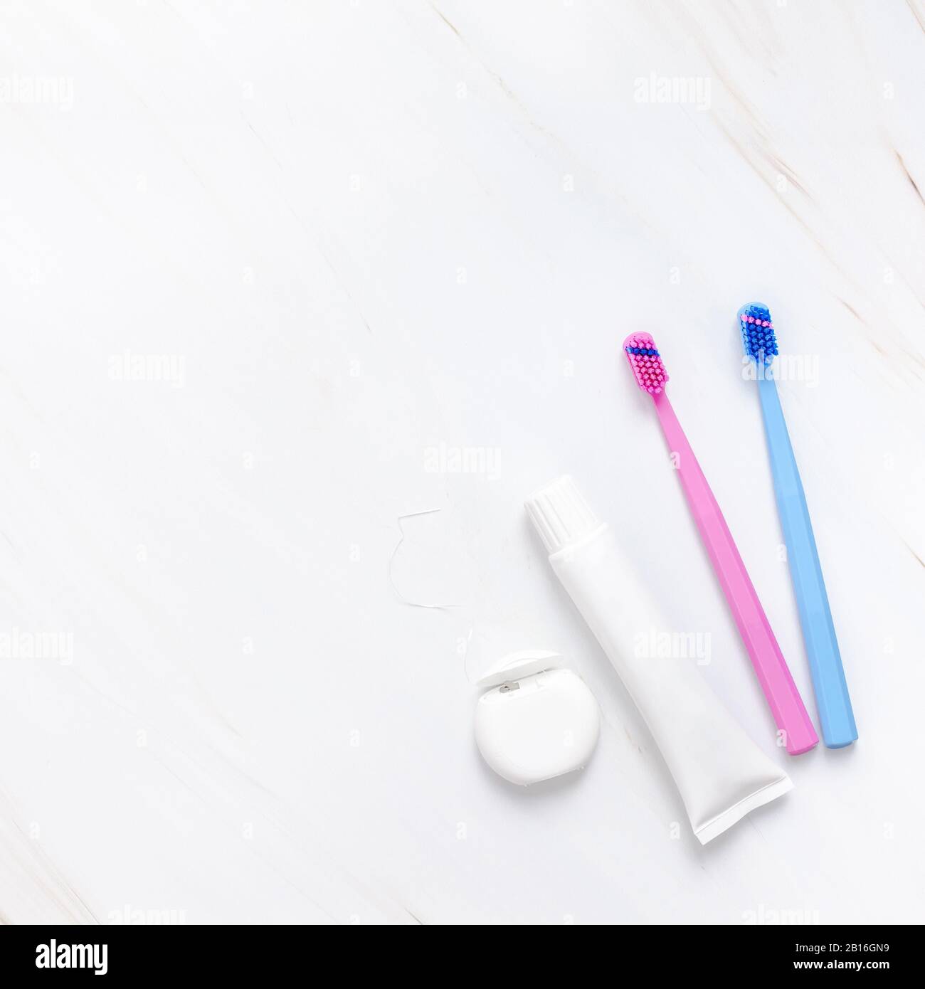 Teeth hygiene and oral dental care products on white marble table ...