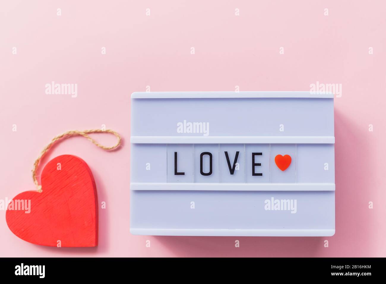 Happy Valentines Day light box message with red flower petals and ...