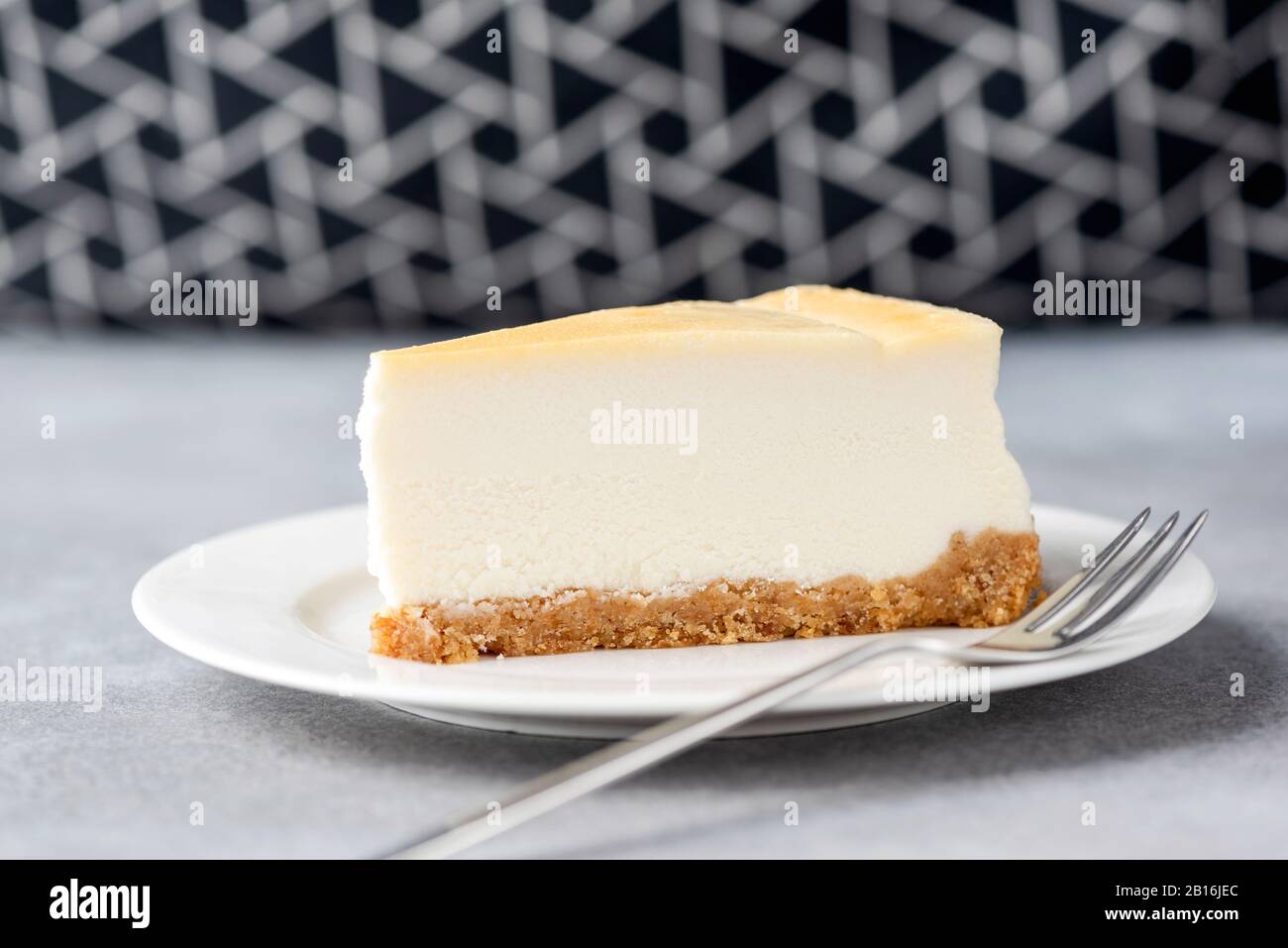Classical cheesecake slice on white plate. Horizontal composition, copy ...