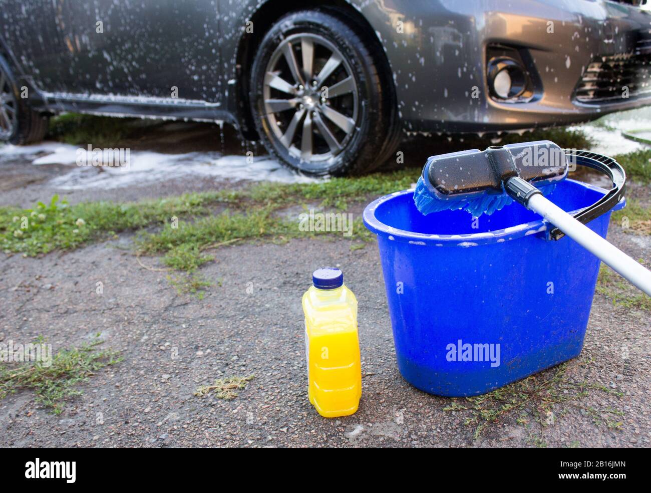 Shampoo and bucket of water for car washing, car cleanliness concept ...