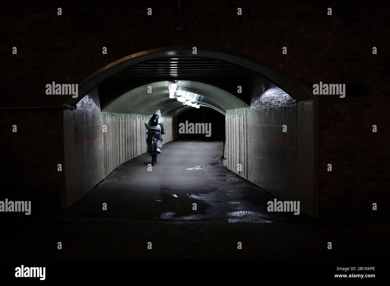 Urban ill lit pedestrian underpass at night, intimidating environment ...