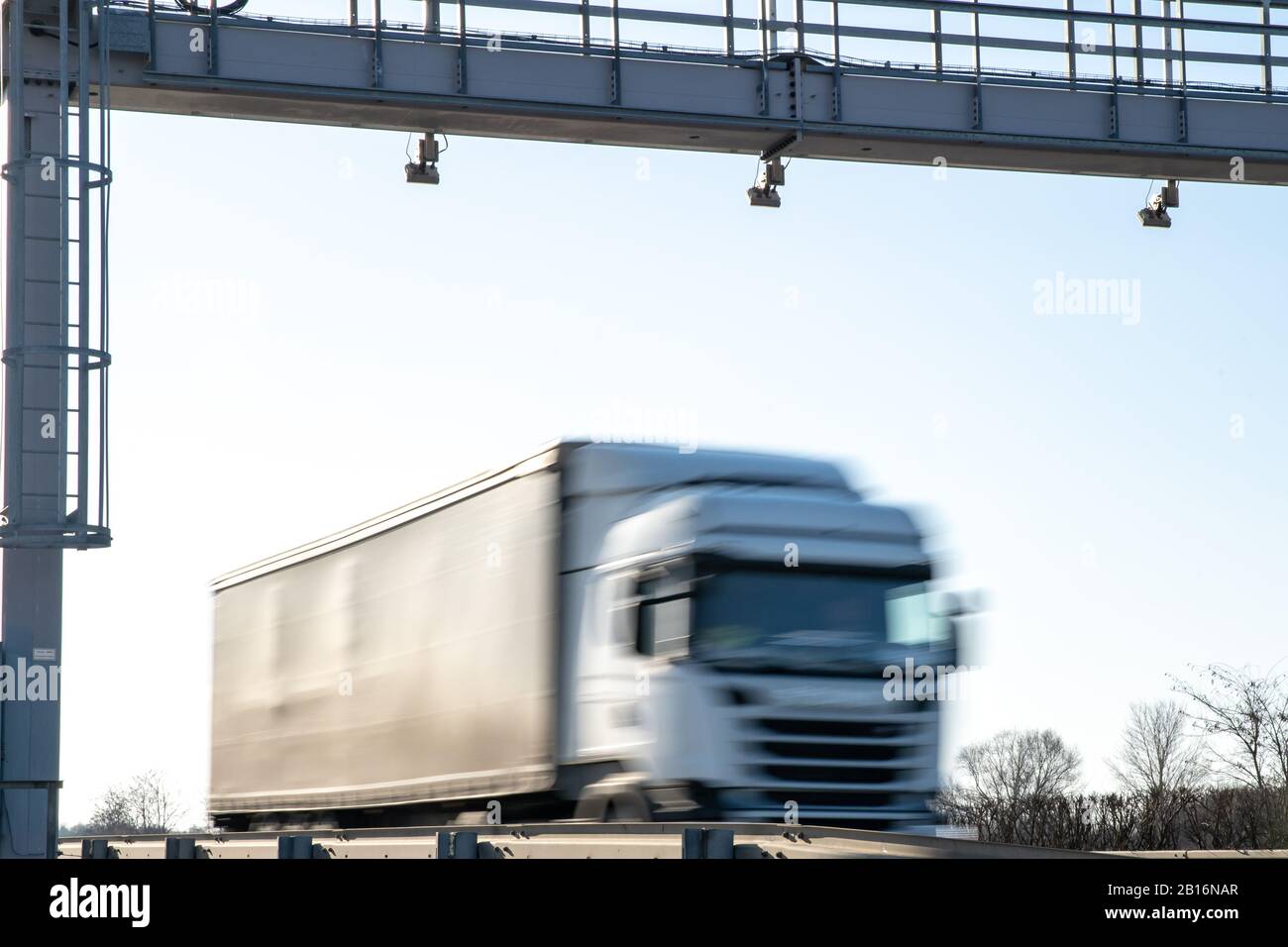 truck drive through the highway through the toll gate, toll charges ...