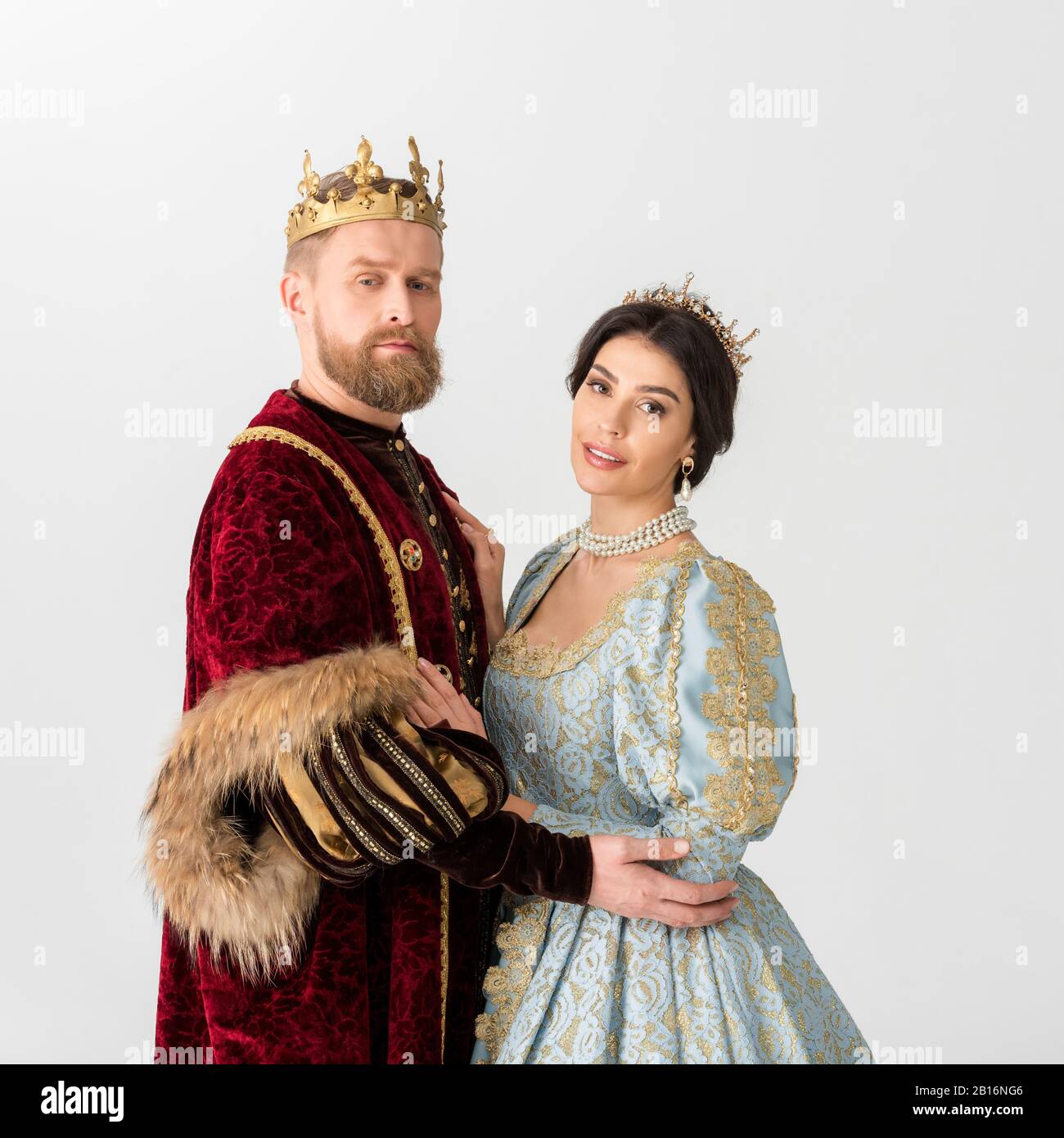smiling queen and king with crowns hugging isolated on grey Stock Photo ...