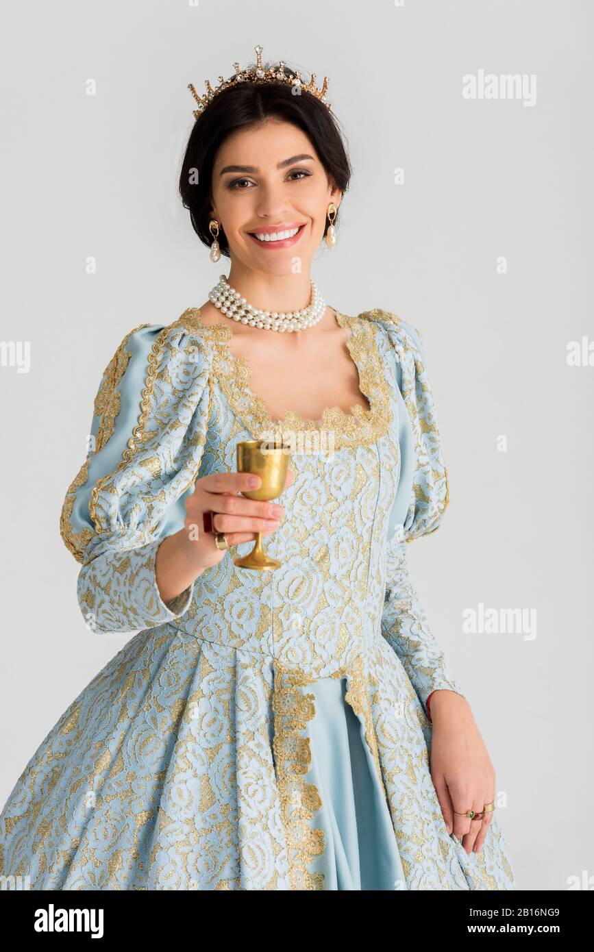 smiling queen with crown holding cup isolated on grey Stock Photo - Alamy