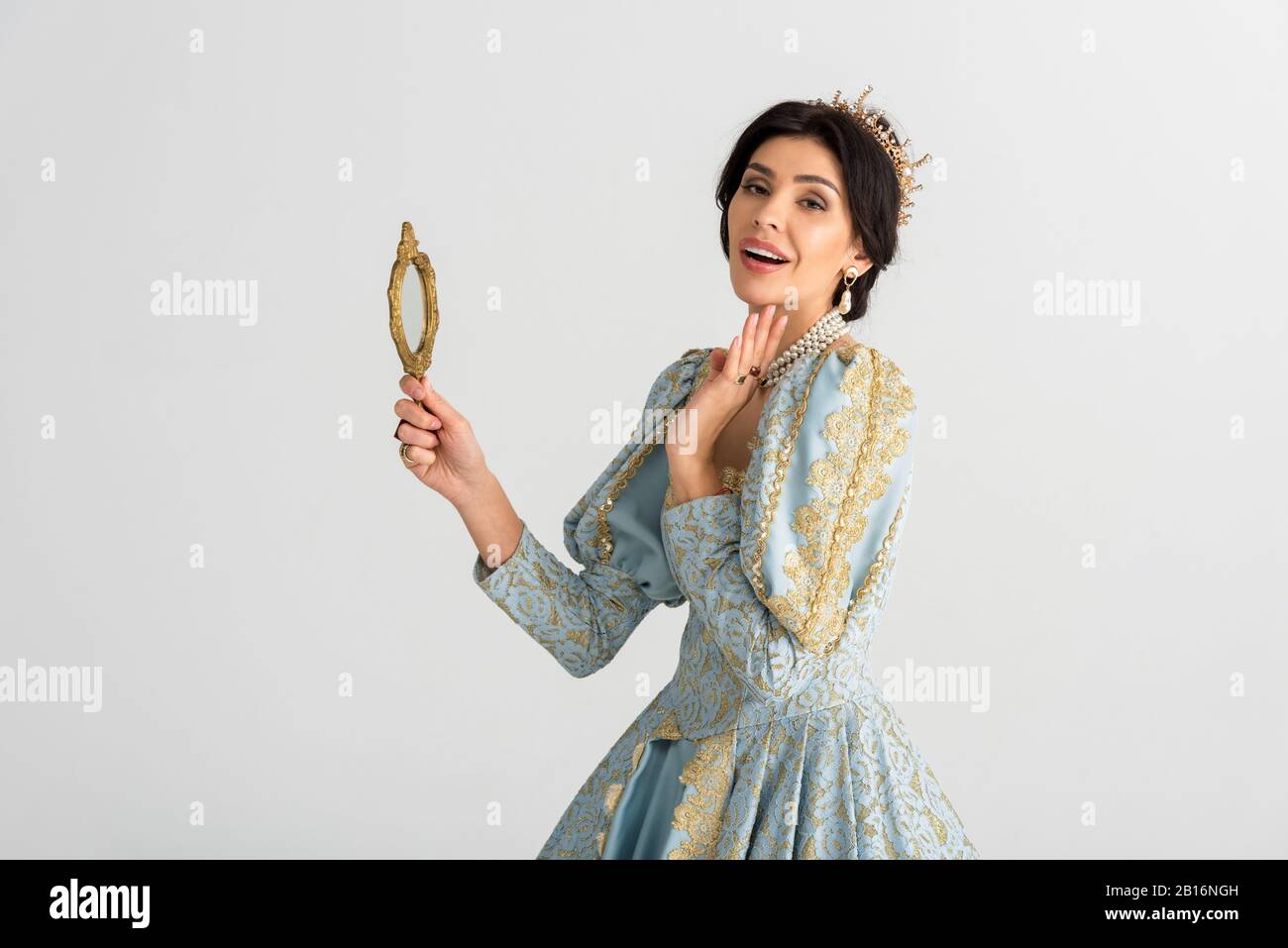 shocked queen with crown holding mirror isolated on grey Stock Photo ...