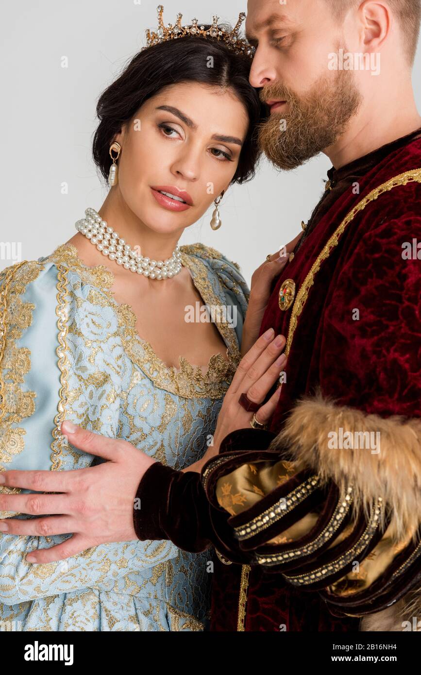 cropped view of king hugging queen with crown isolated on grey Stock ...