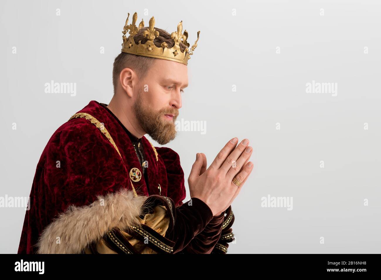 side view of king with crown praying isolated on grey Stock Photo - Alamy