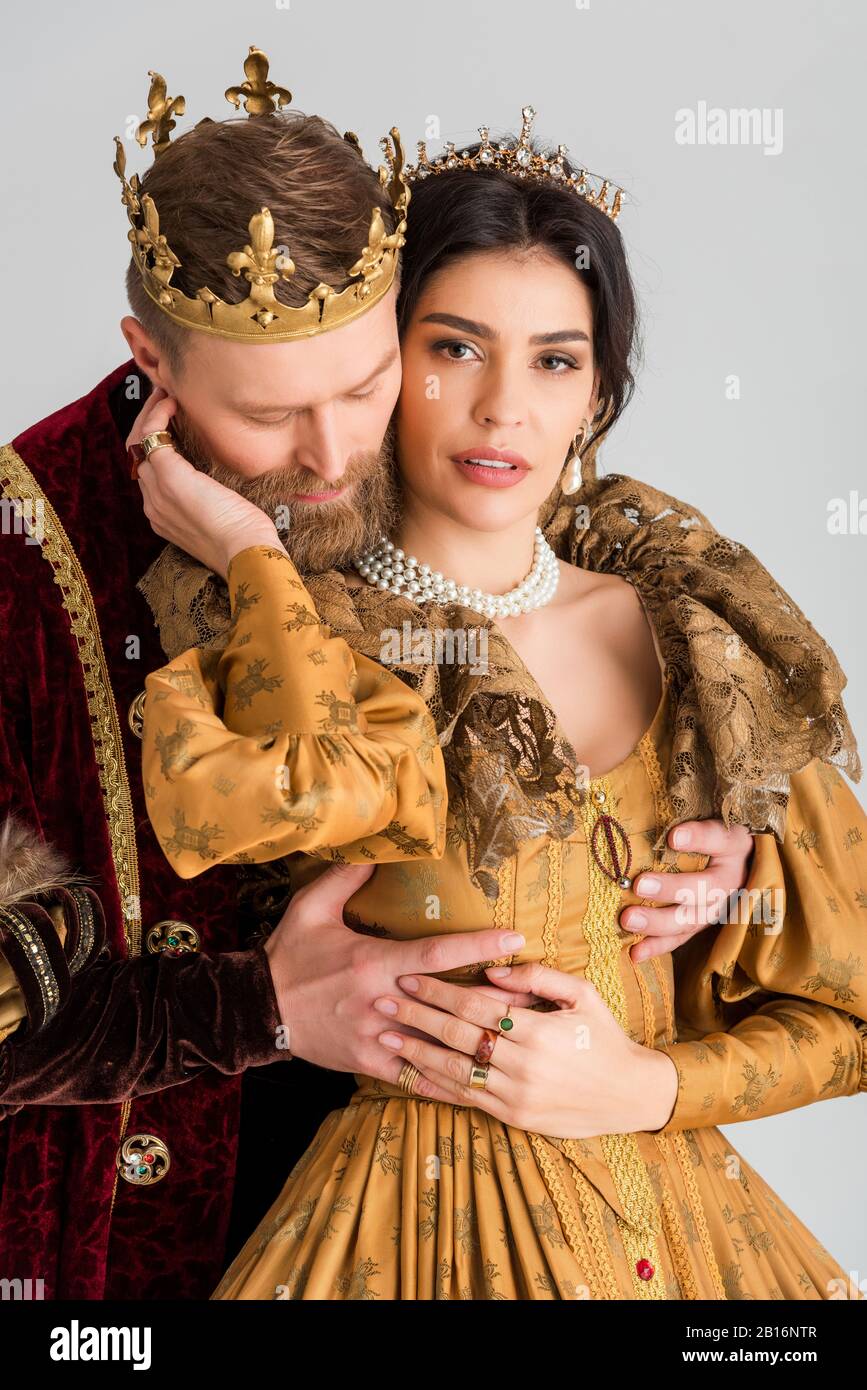 king with crown hugging attractive queen isolated on grey Stock Photo ...