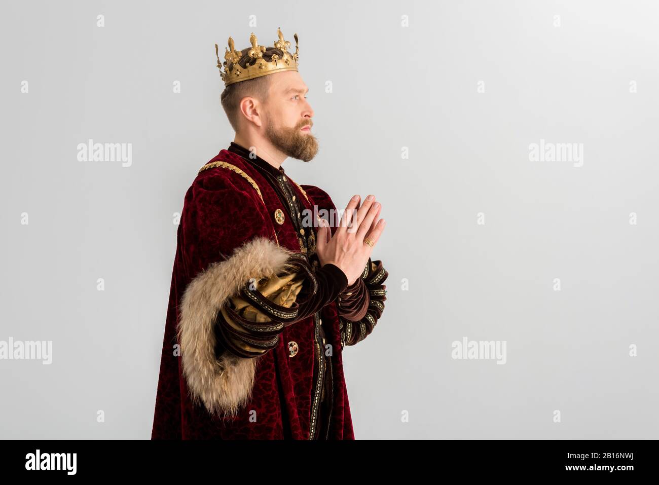side view of king with crown praying isolated on grey Stock Photo - Alamy