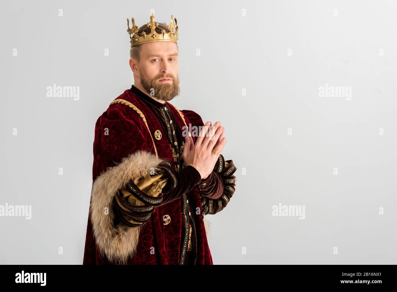 king with crown showing praying hands isolated on grey Stock Photo - Alamy