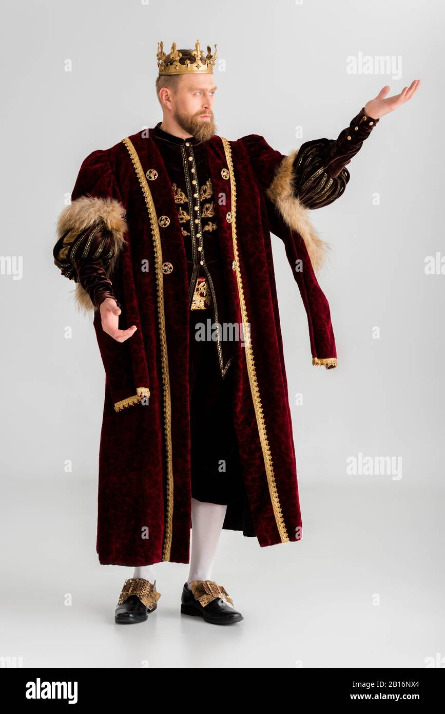 king with crown pointing with hand on grey background Stock Photo - Alamy