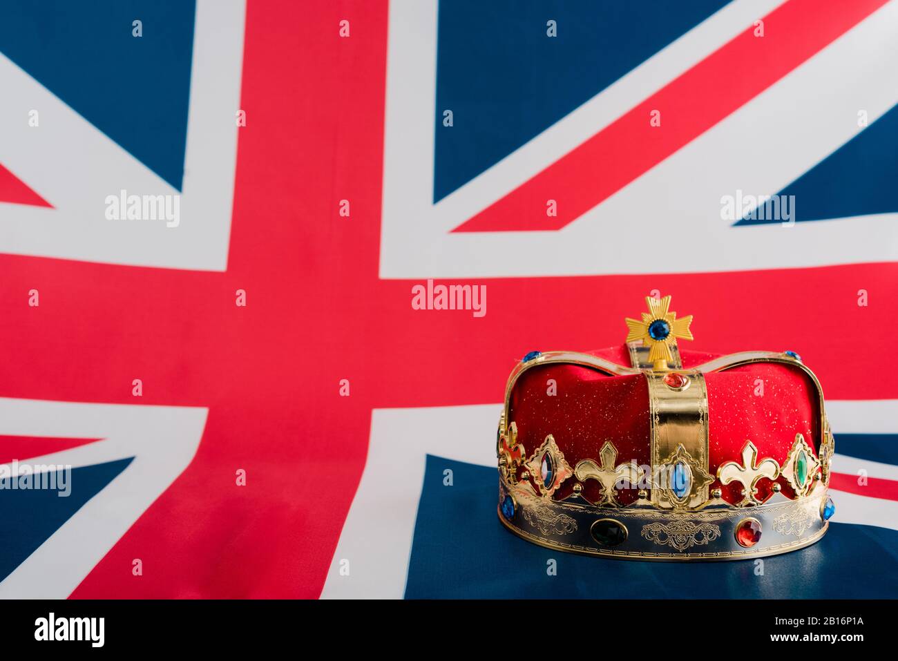 golden crown on british flag with copy space Stock Photo - Alamy