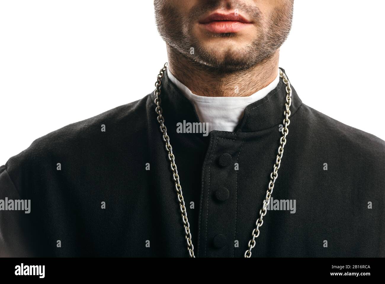 cropped view of catholic priest in black cassock standing isolated on ...
