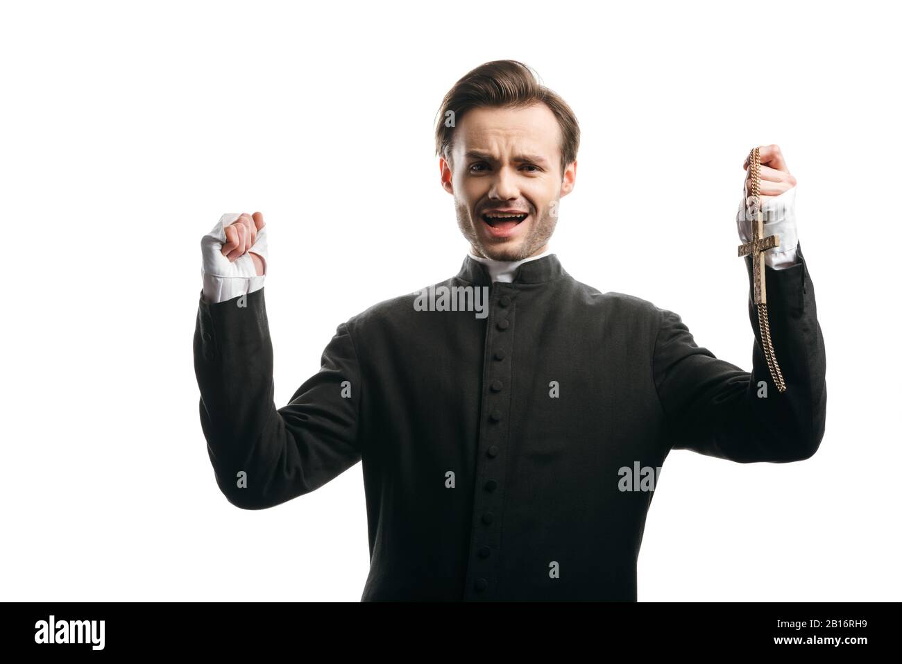 angry catholic priest screaming at camera while holding raised fist and ...