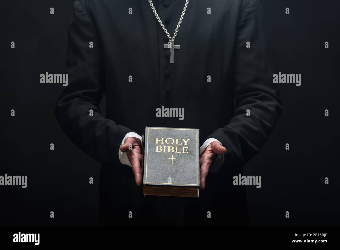 Catholic priest holding holy bible hi-res stock photography and images ...
