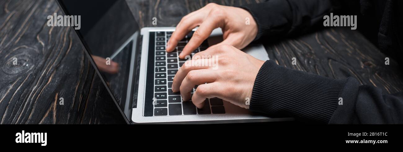 Hacker typing on laptop hi-res stock photography and images - Alamy