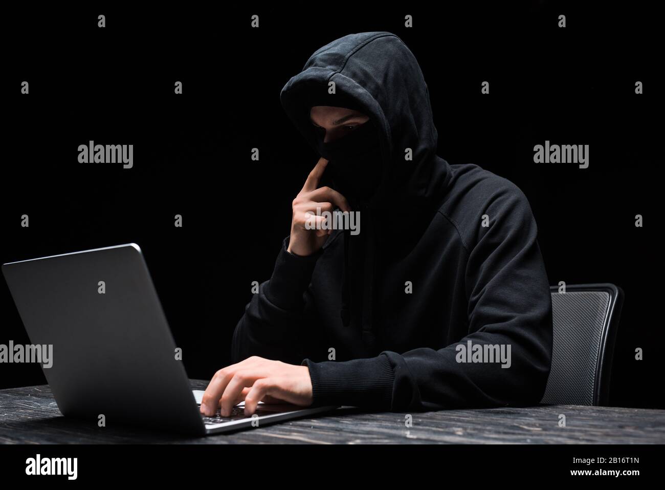 Hacker anonymous mask using laptop hi-res stock photography and images ...