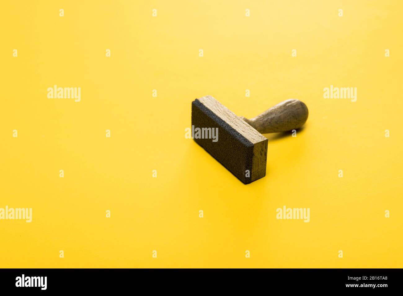 wooden stamp on yellow, quality concept Stock Photo - Alamy