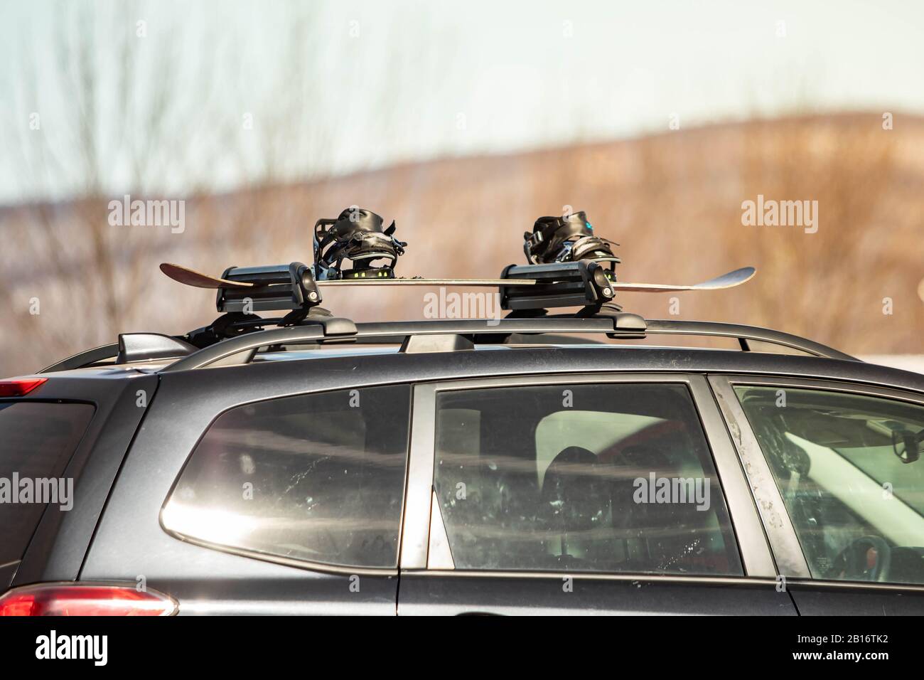 Car hood mount for skies and snowboards with snowboard nobody at day ...