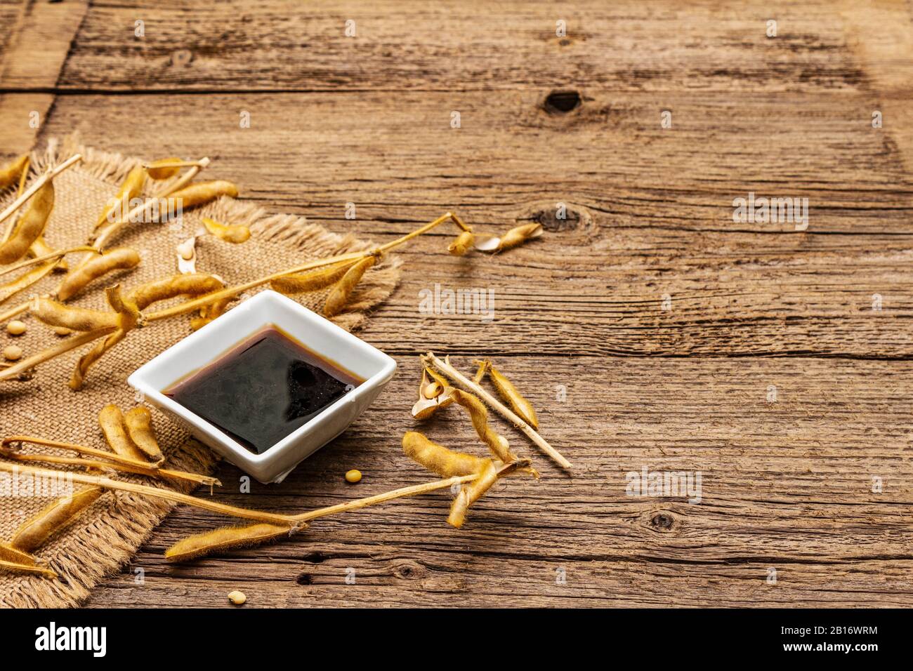 Ripe dry soybeans in pods and dark soy sauce. Cultivated organic ...