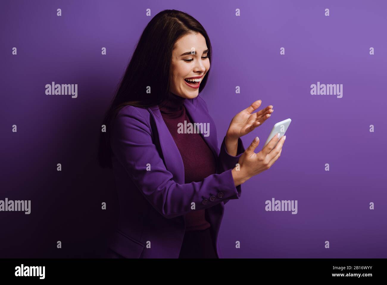 excited girl standing with open arm and laughing while having video ...