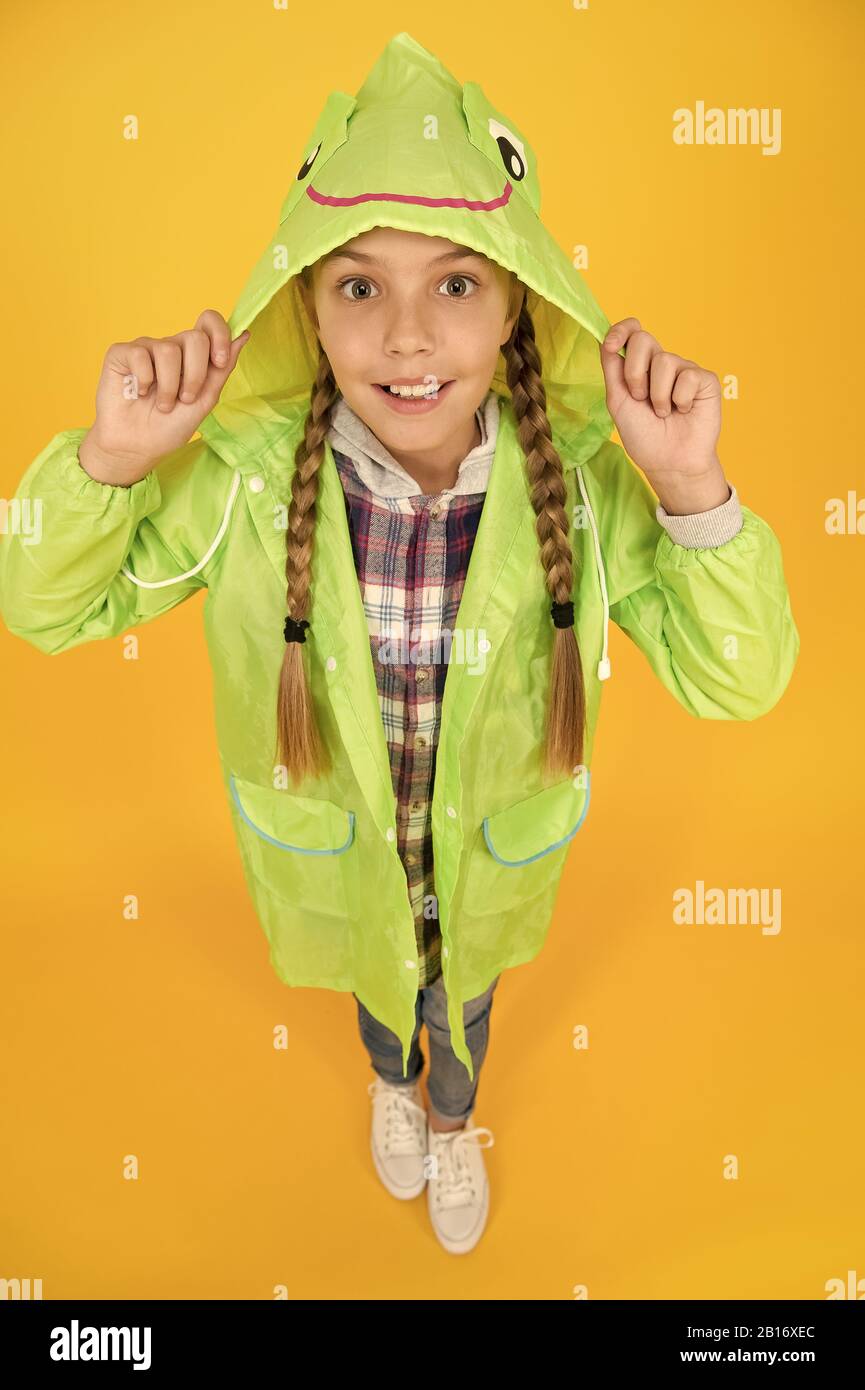 Rainproof accessory. Schoolgirl hooded raincoat enjoy rainy weather ...