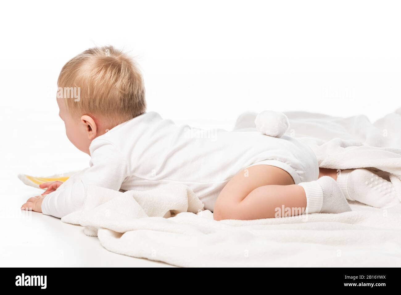 Side view of cute child lying on blanket on white background Stock ...