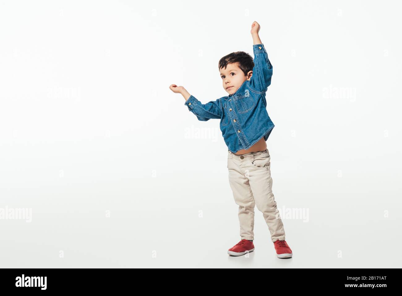 cute boy in denim shirt showing yes gesture on white background Stock ...