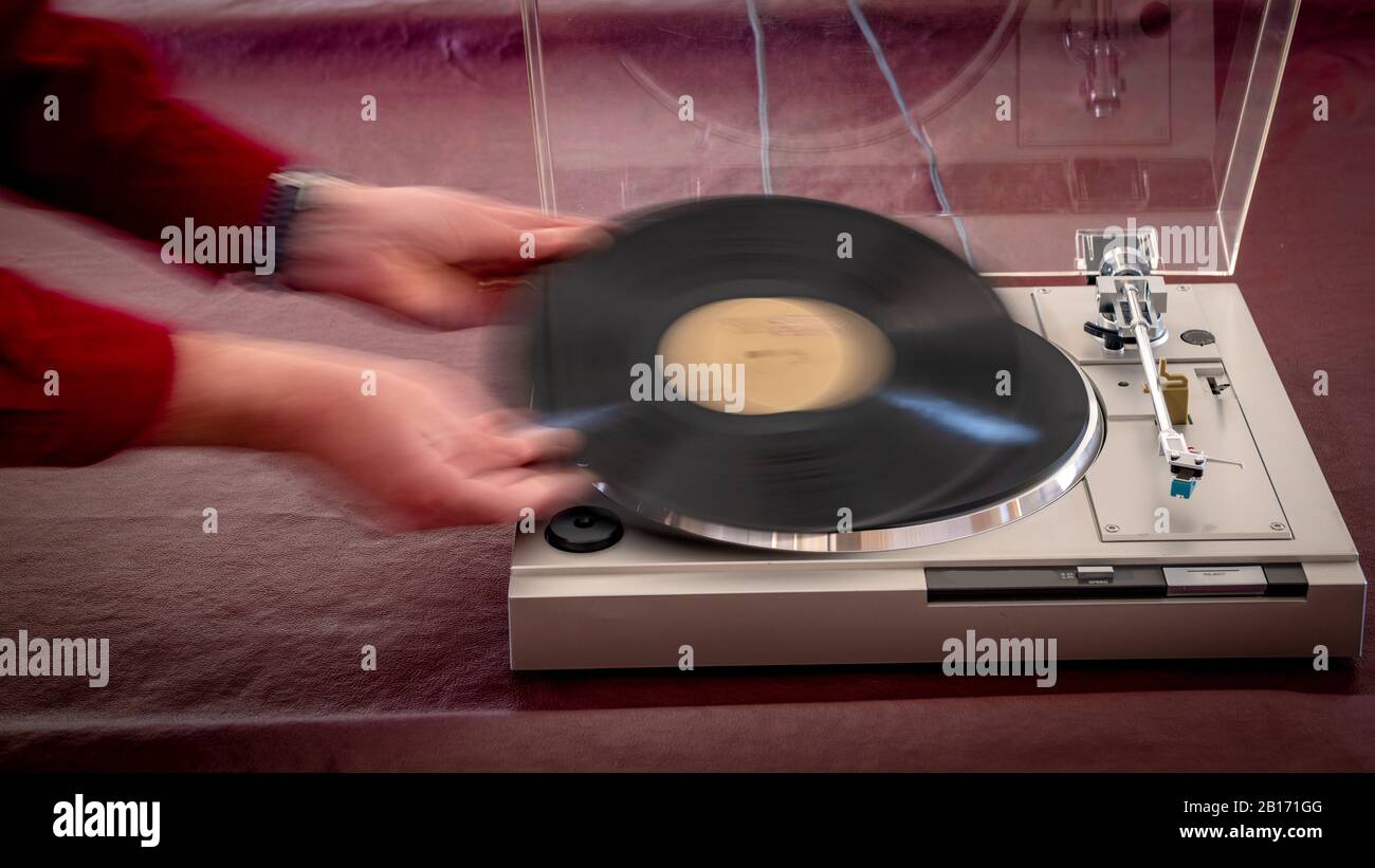 Motion of putting a new record on a record player Stock Photo - Alamy