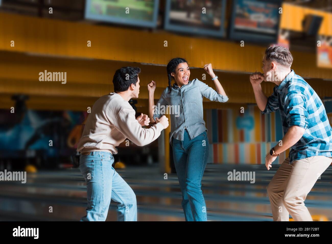 excited african american girl with multicultural friend showing winner ...