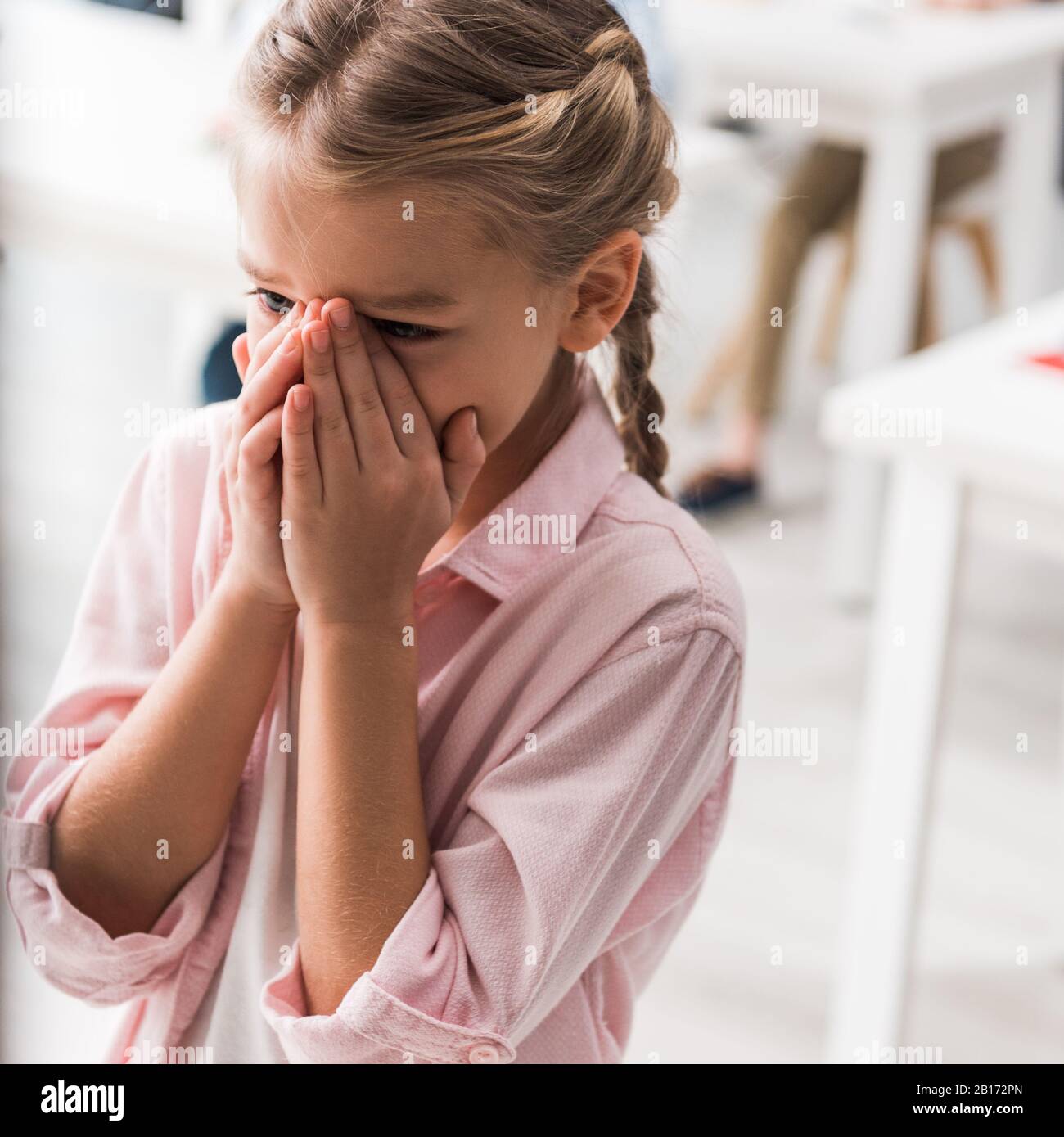 upset schoolkid crying in classroom, bullying concept Stock Photo - Alamy