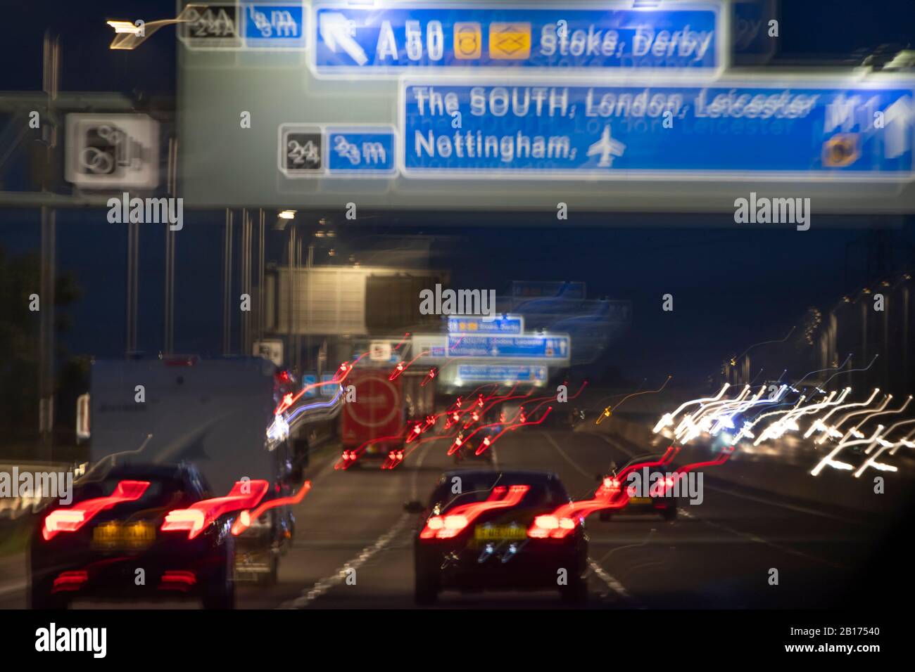 Motorway traffic and signs at night, at Junction 23A on the M1, Castle ...