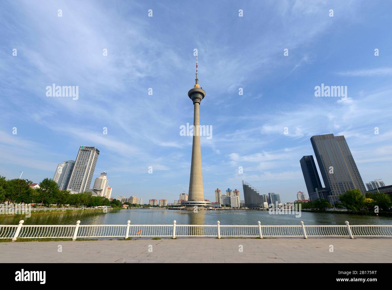 Tianjin TV tower, Tianjin, China, seen across the water of a lake and ...