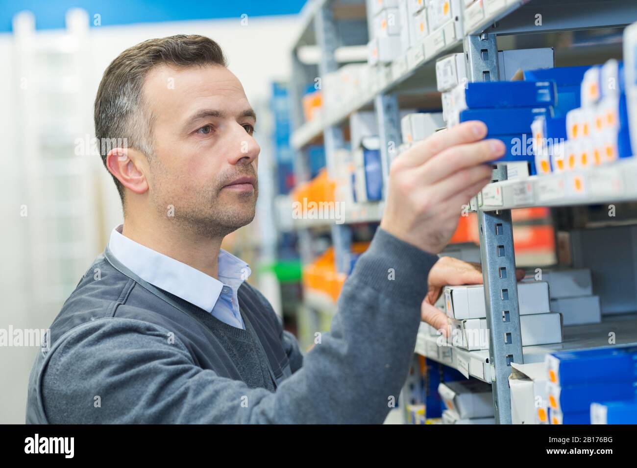worker selecting package from racking in storeroom Stock Photo - Alamy
