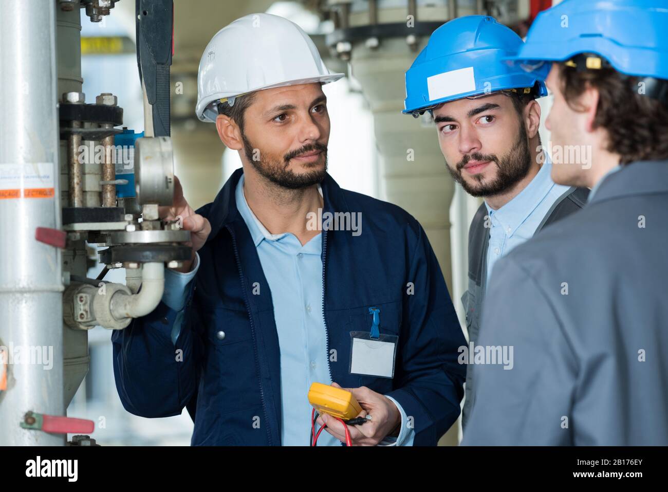 three men discussing future wind power station project Stock Photo - Alamy