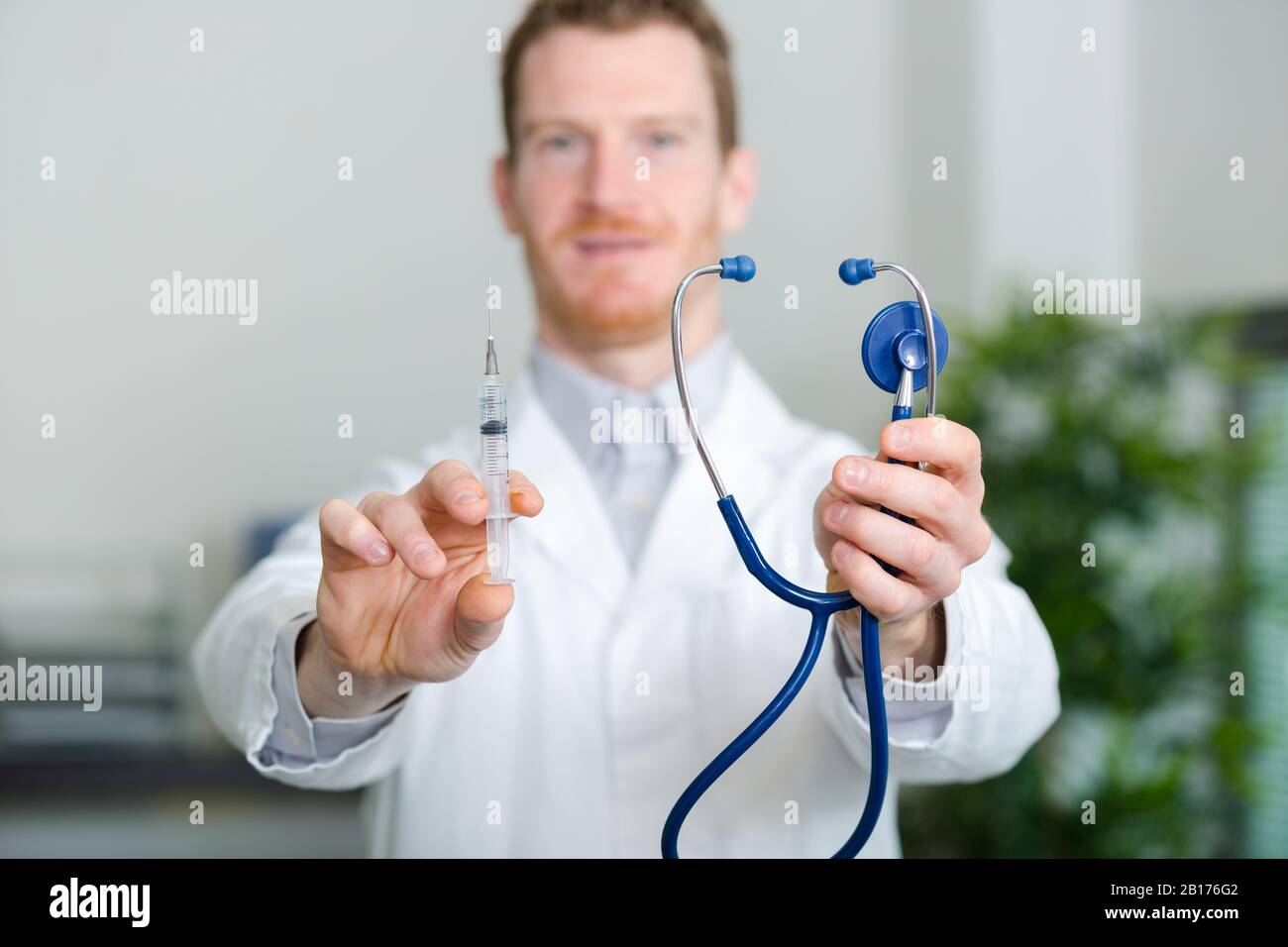 portrait of doctor showing injection Stock Photo - Alamy