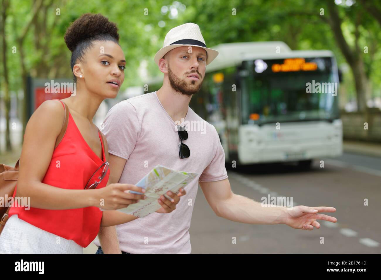 Two young women bus stop hi-res stock photography and images - Alamy