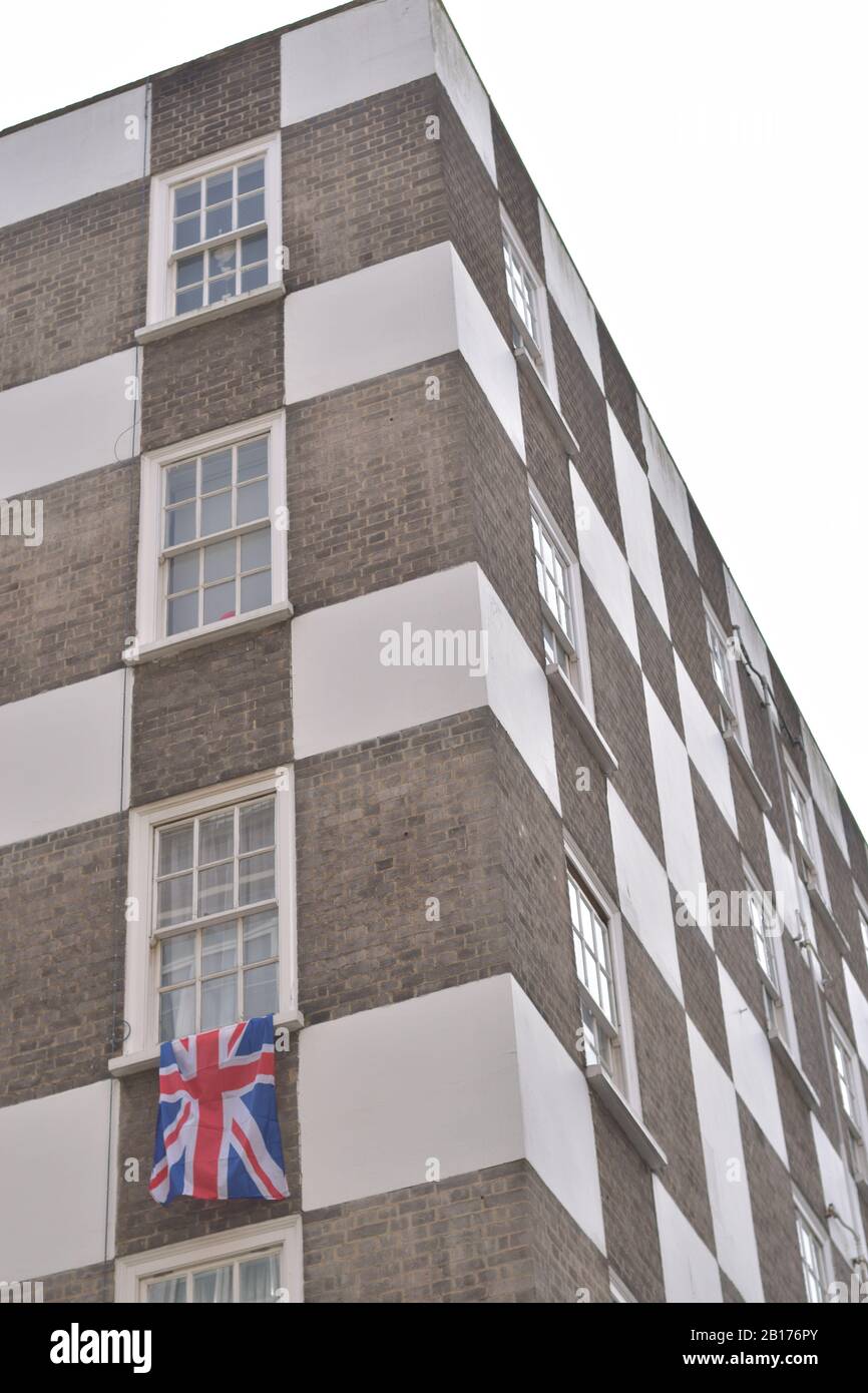 Union Jack flag hanging out of window in block of flats Stock Photo - Alamy