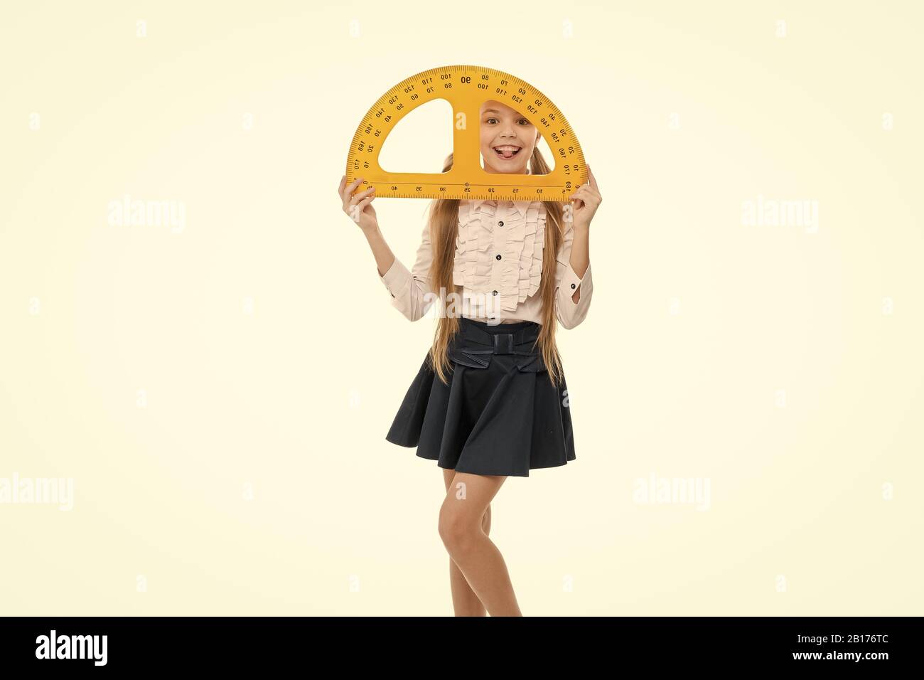 Little girl hold protractor and ruler for lesson. Small child with ...