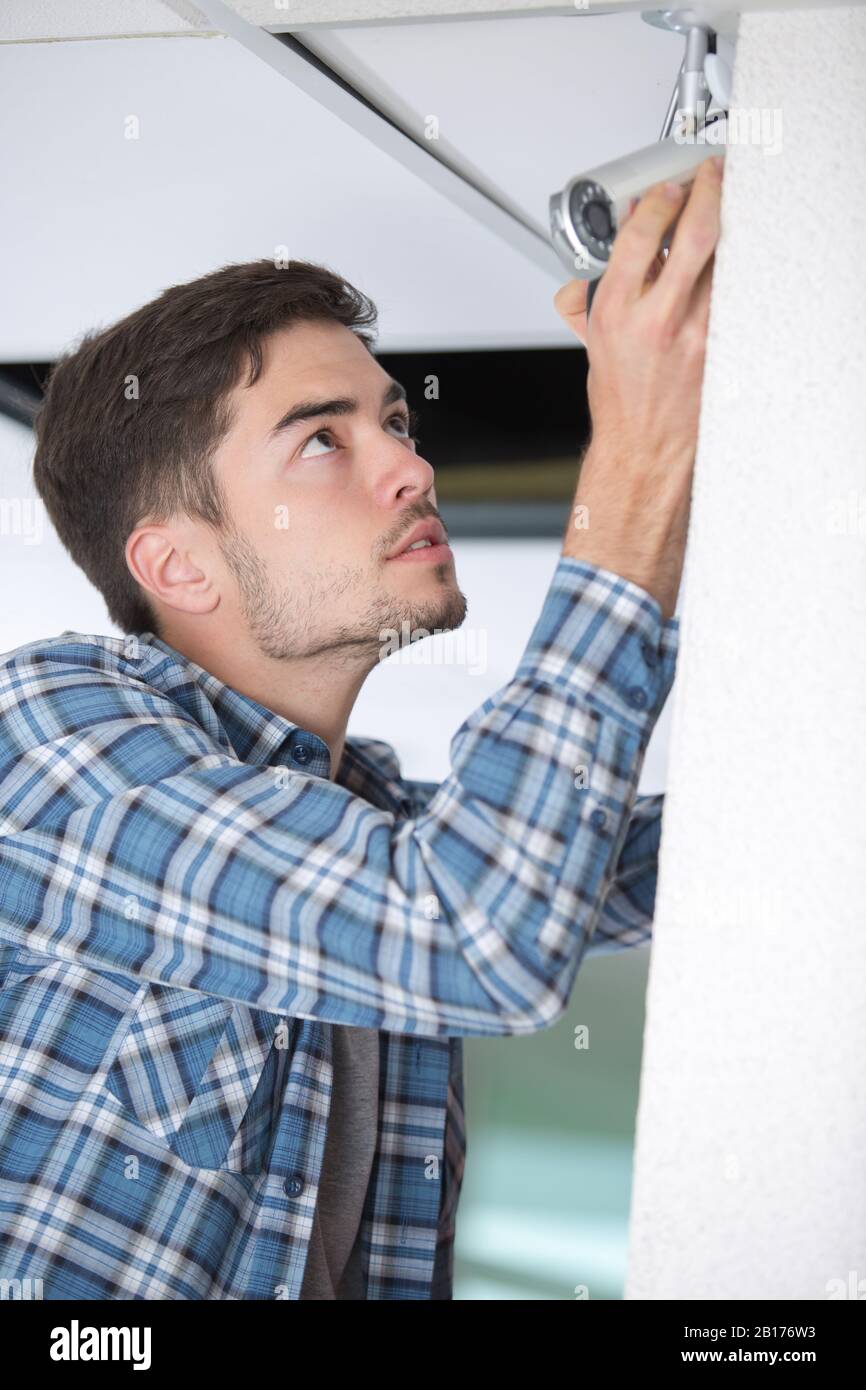 technician worker installing video surveillance camera on wall Stock ...