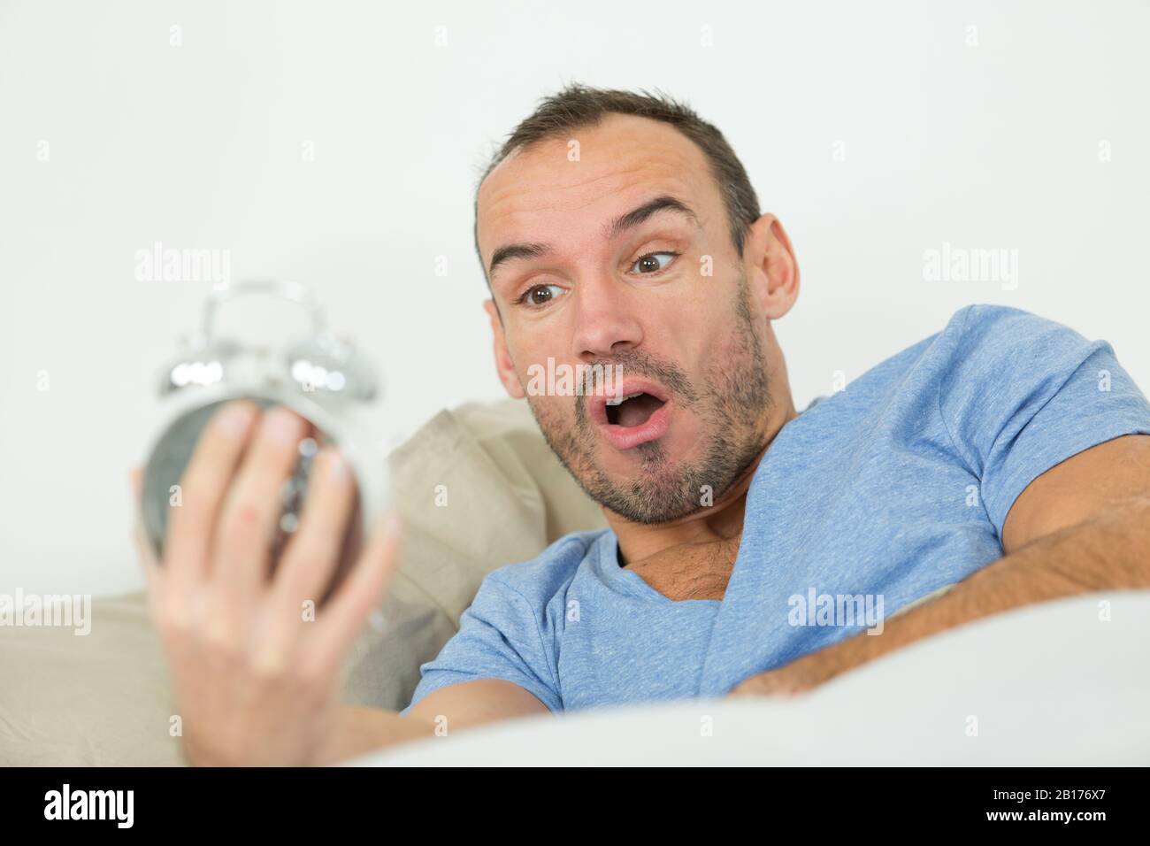 young man is stressed and shocked about the time Stock Photo - Alamy