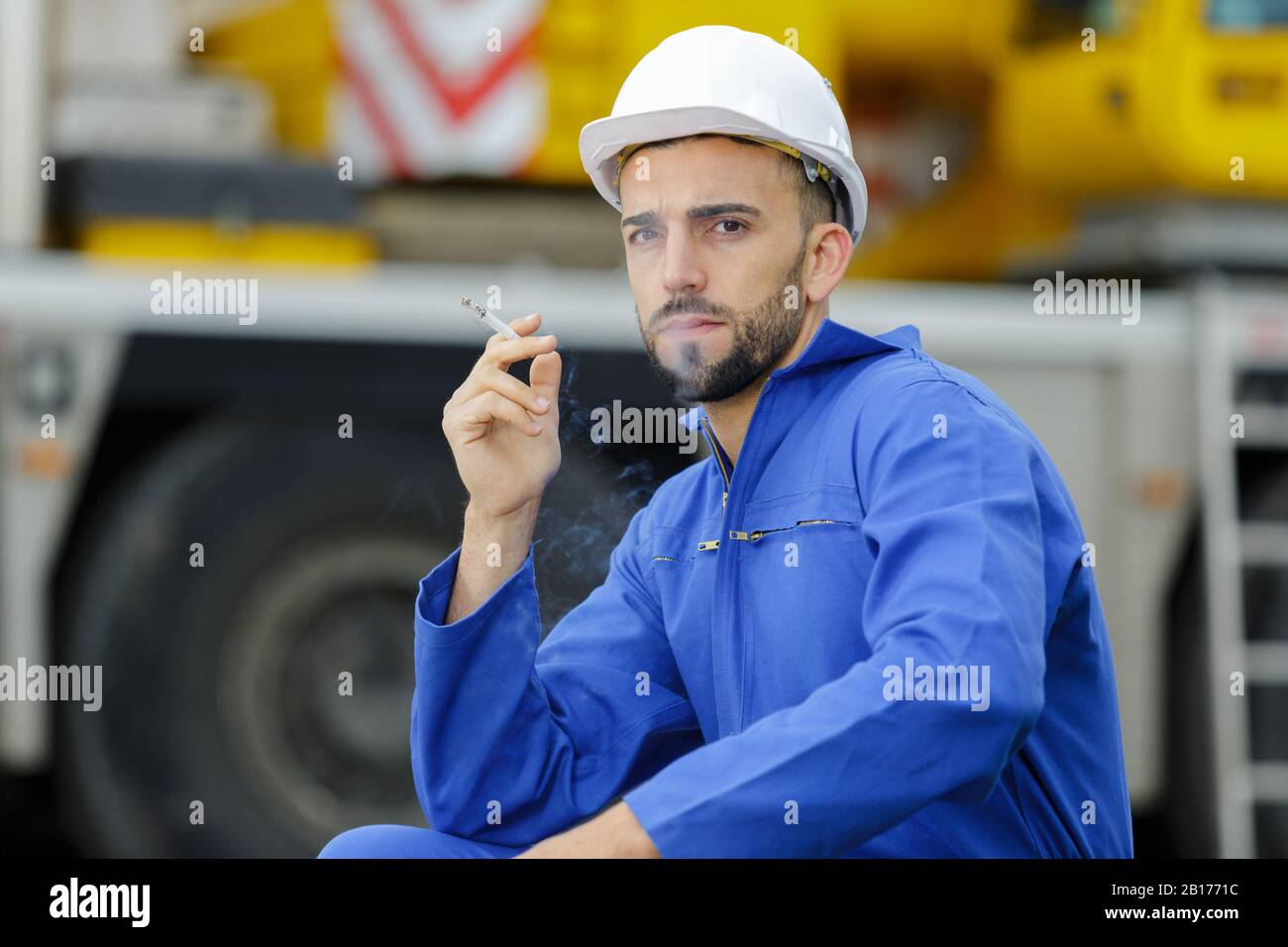 manual worker smoking a cigarette Stock Photo - Alamy